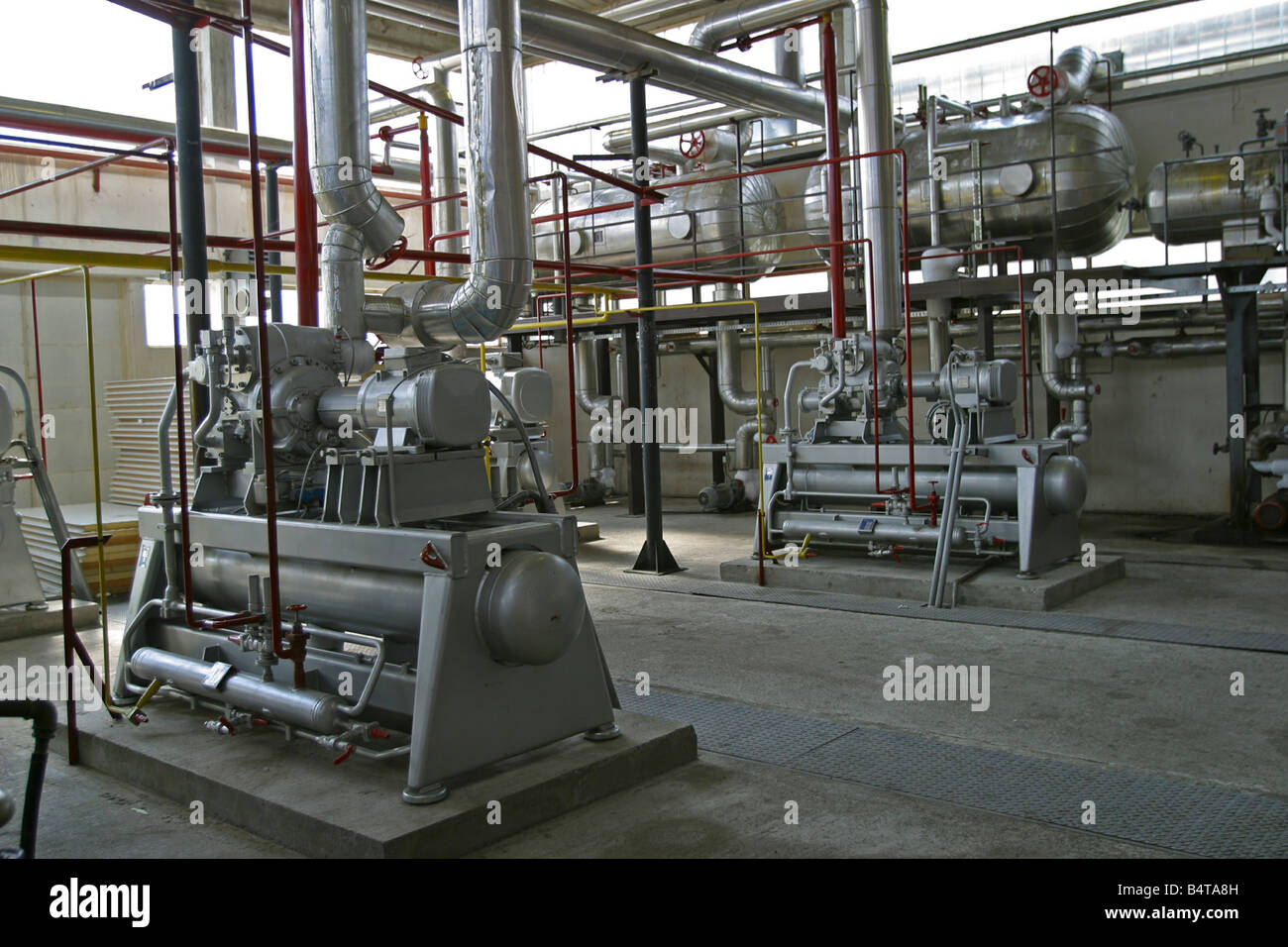 industrial compressors and pipe work in factory Stock Photo - Alamy