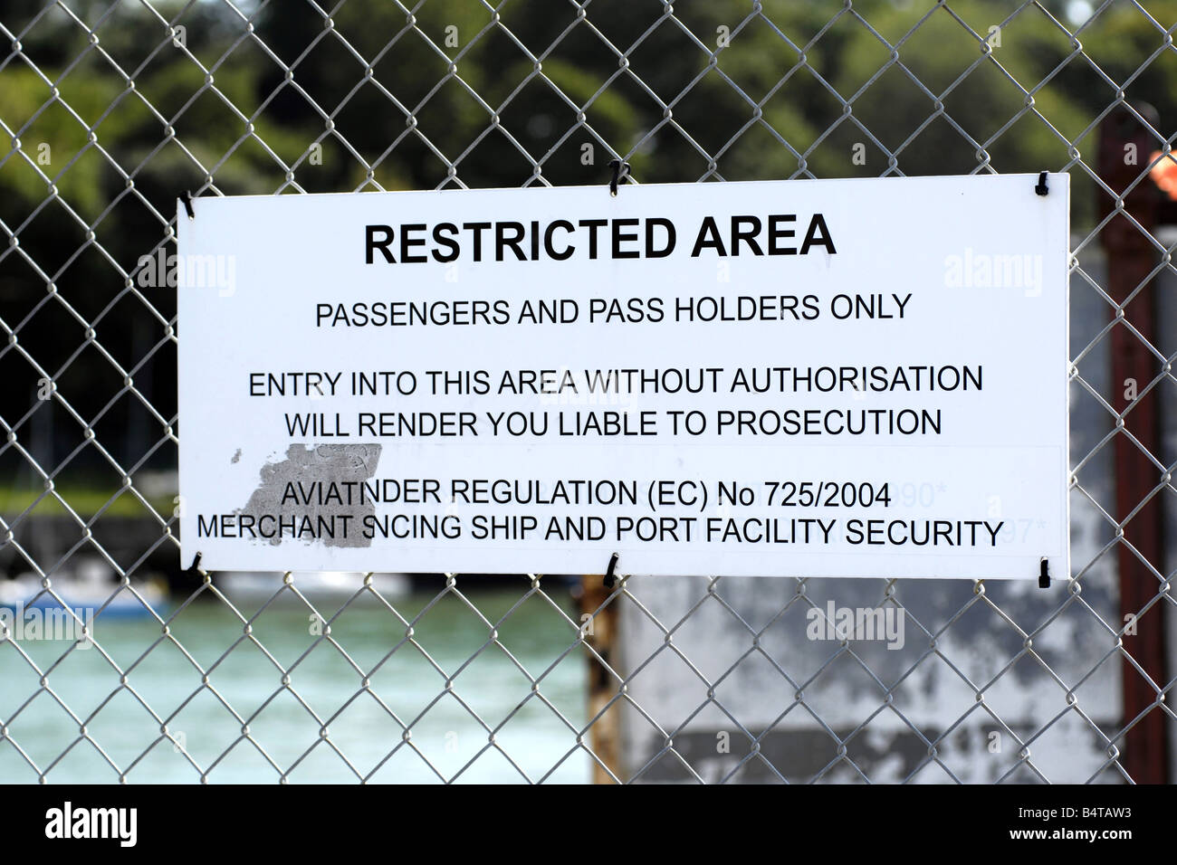 A Restricted Area sign fixed to a chain linked fence Stock Photo - Alamy