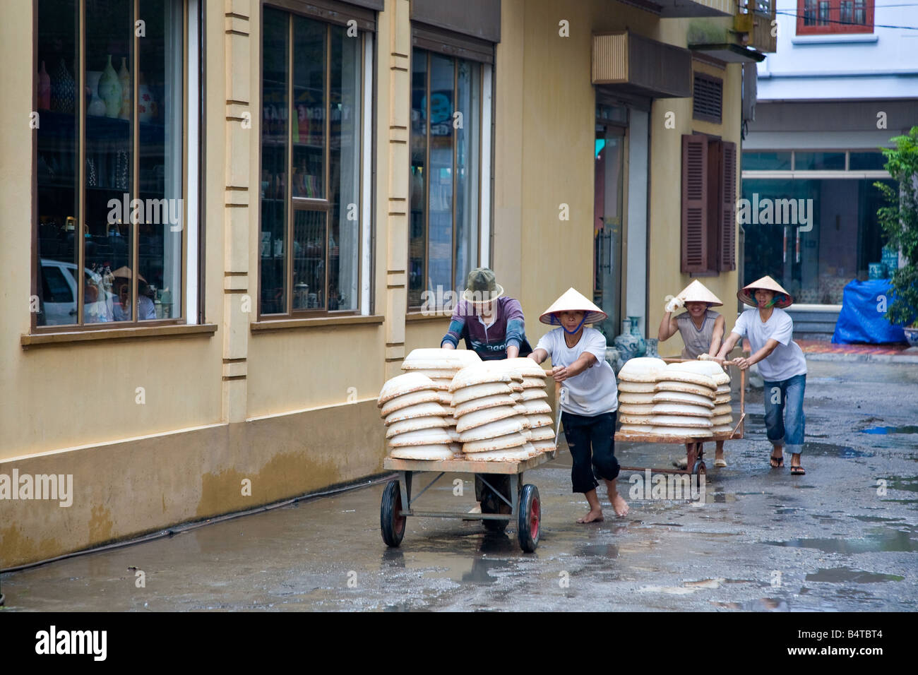 Workers pushing cart full of ceramic for transport to market Stock ...