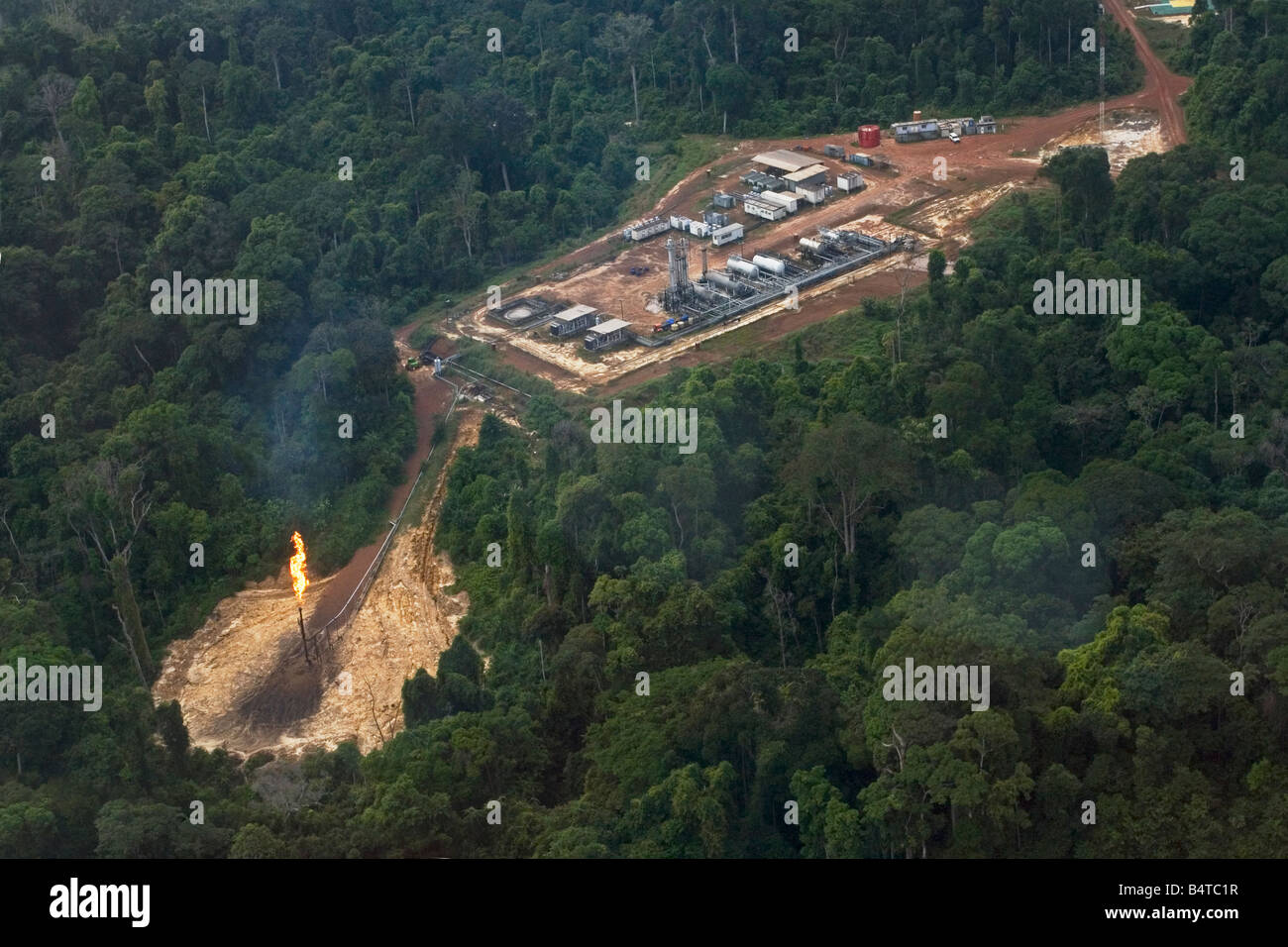 Aerial of onshore oil and gas well rig site showing processing plant ...