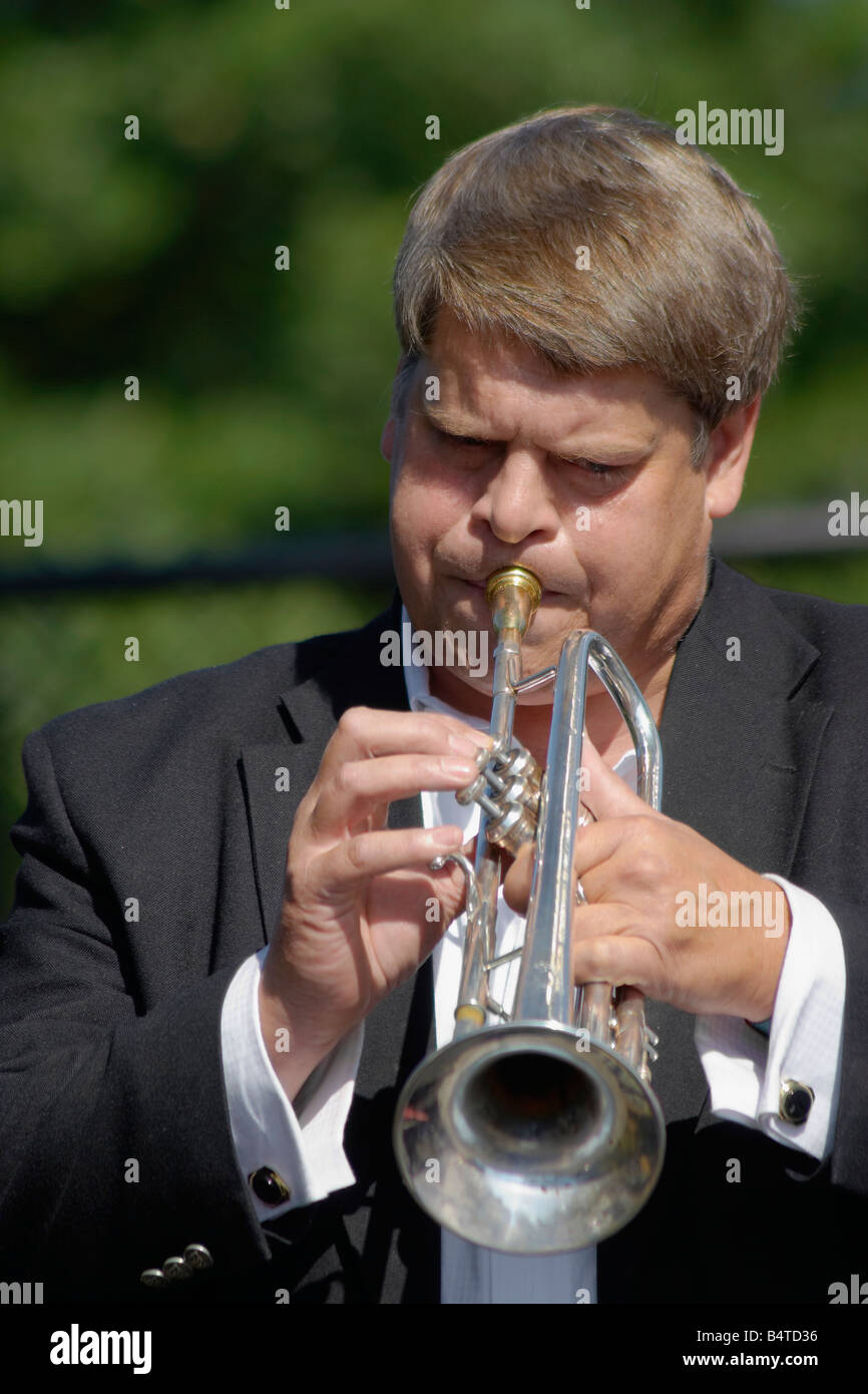 A trumpet player performs in an outdoor jazz band concert Stock Photo ...