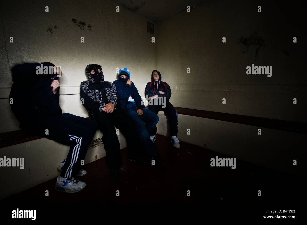 Gang of four youths wearing face masks wait in a dark prison cell Stock ...