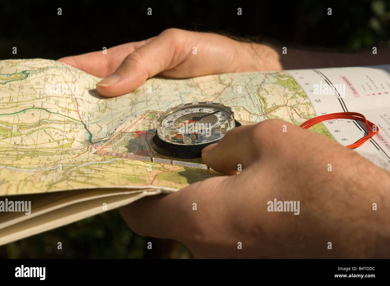 Man looking at a Traditional Map and Compass close up Stock Photo - Alamy