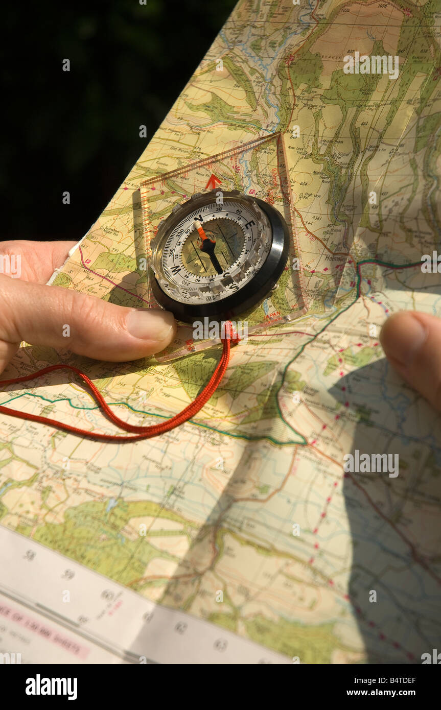 Checking directions of a walking route on an ordnance survey paper map ...