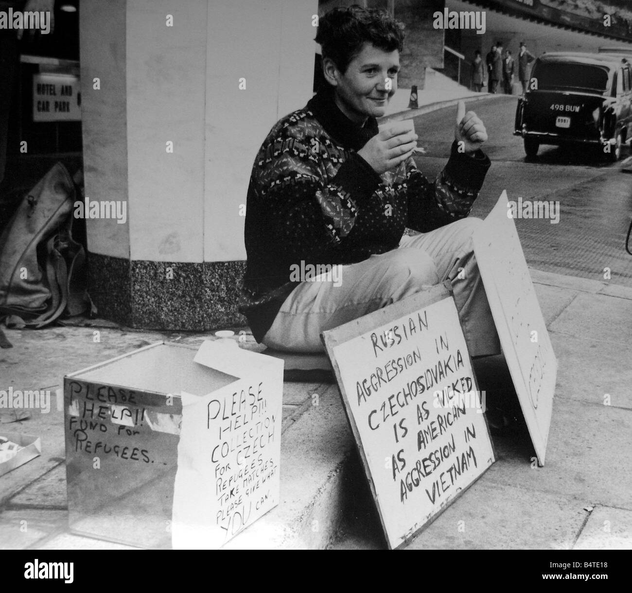 Pacifist campaigner Pat Arrowsmith sitting on the kerb with collection ...