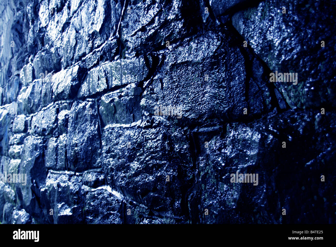 detail of dark damp wet stone wall in alley way Stock Photo - Alamy
