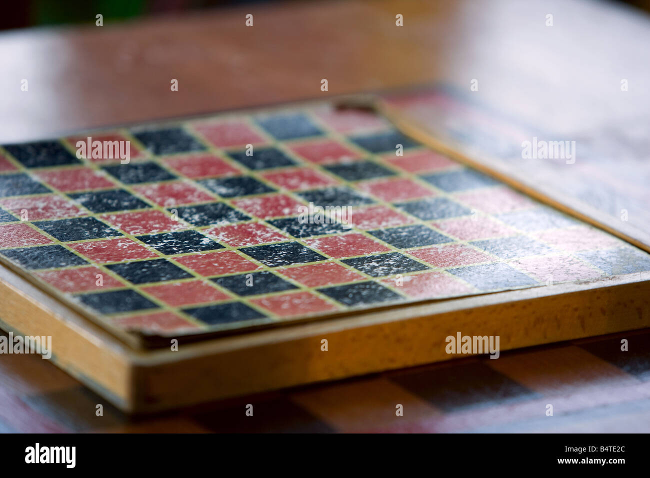 An old checkerboard on a wooden table Stock Photo - Alamy