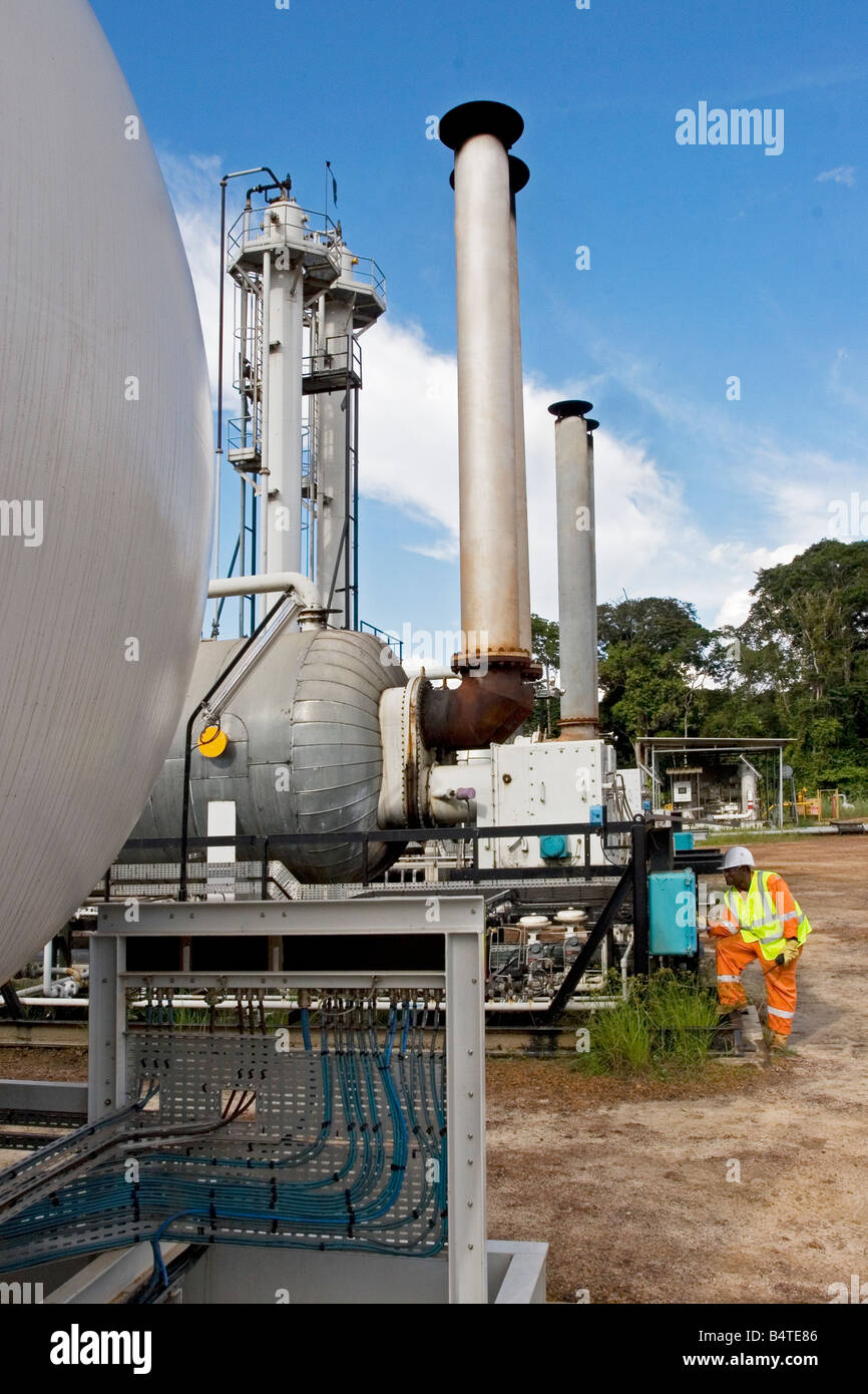 Onshore oil processing plant showing pipework and tanks with oil ...