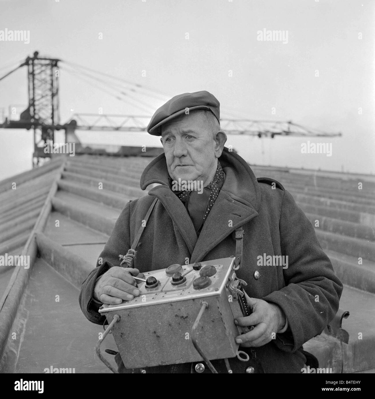 Crane driver using a remote control box on the roof of the Shell Mex ...