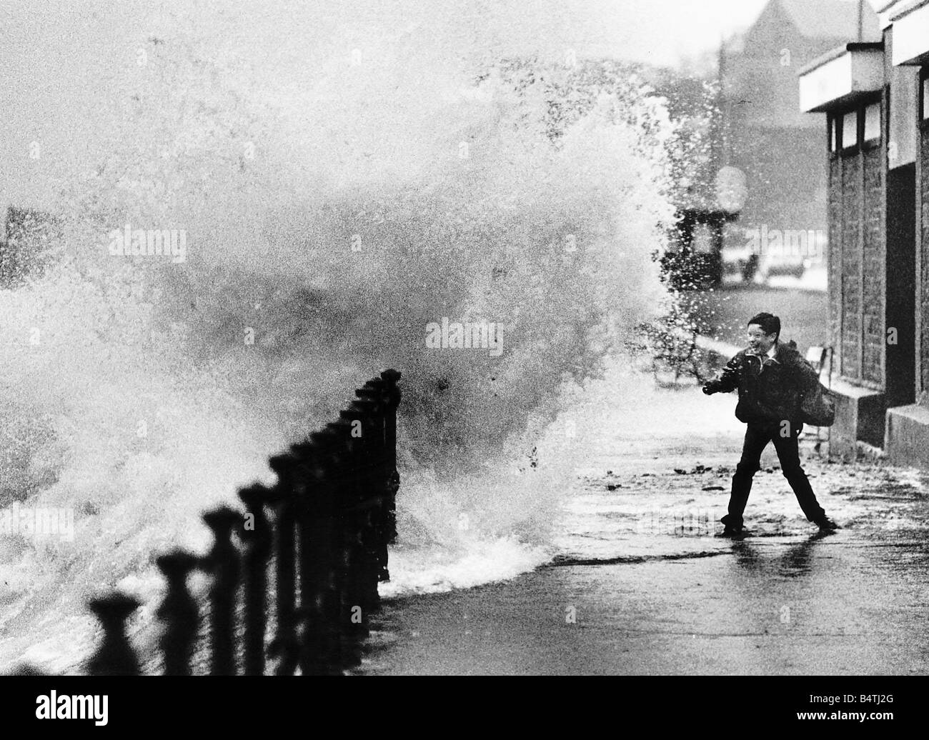 Views A child is soaked as a huge wave crashes over the sea front at ...