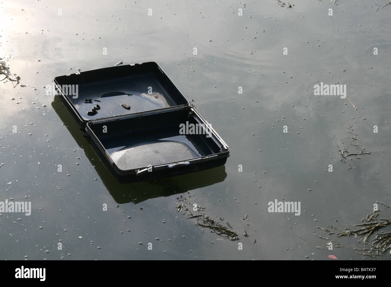one empty suitcase luggage floating in river Stock Photo - Alamy