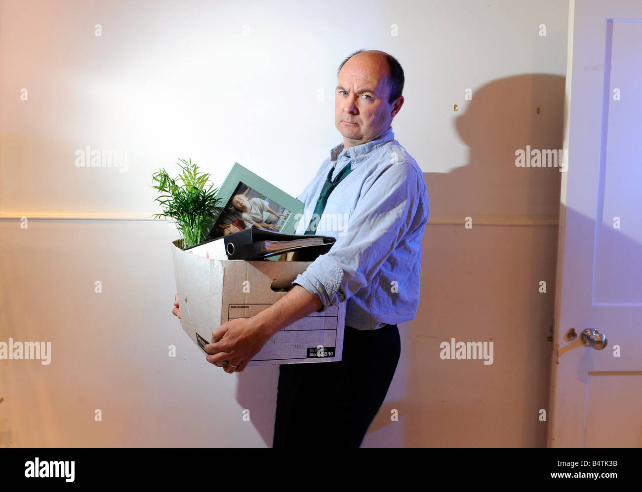 Man packs up and leaves the office after losing his job, being made ...
