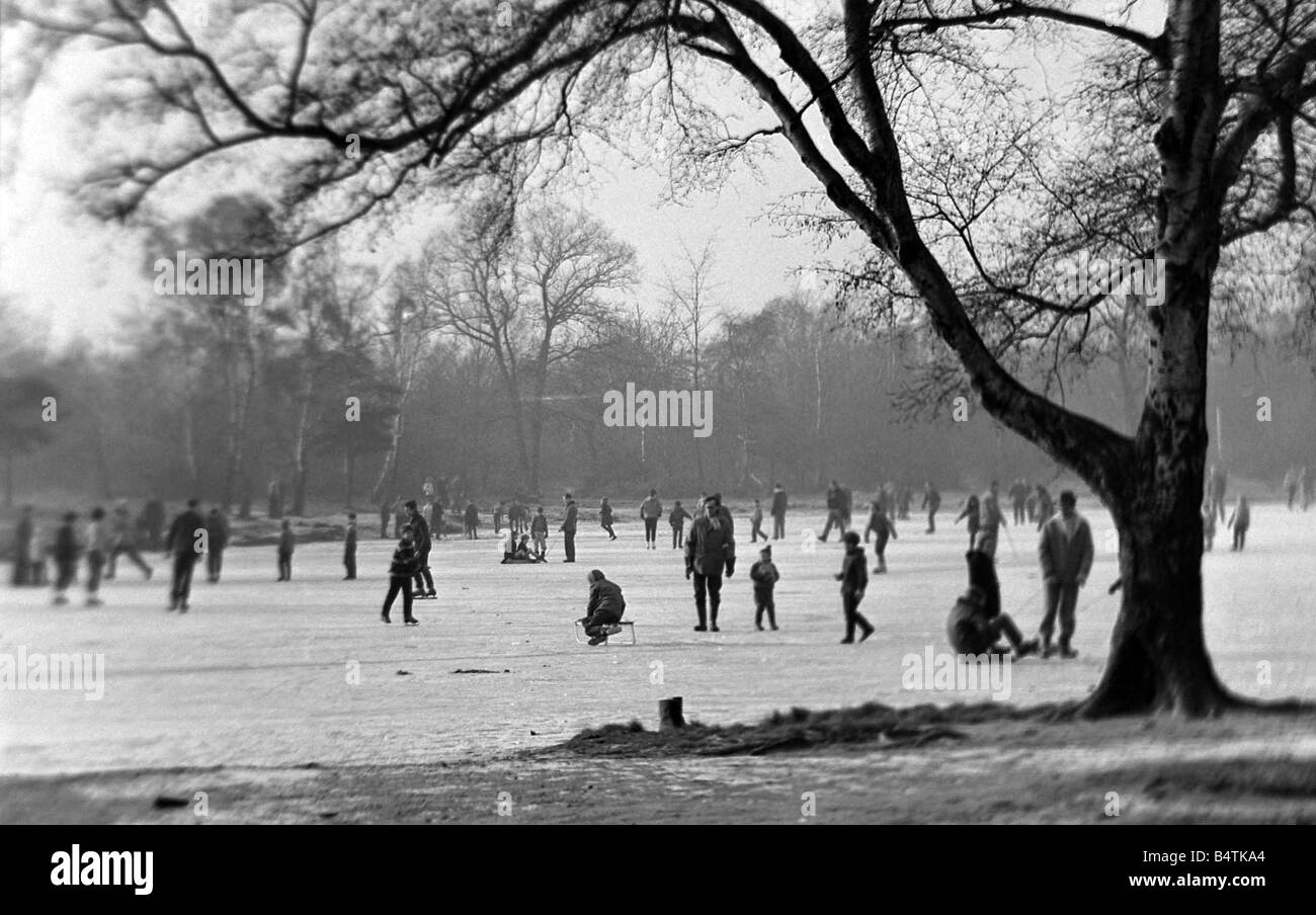 Weather Cold Snow People skating on a frozen pond lake Stock Photo - Alamy