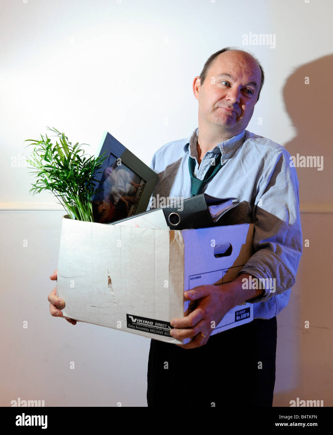 Man packs up and leaves the office after losing his job, being made ...