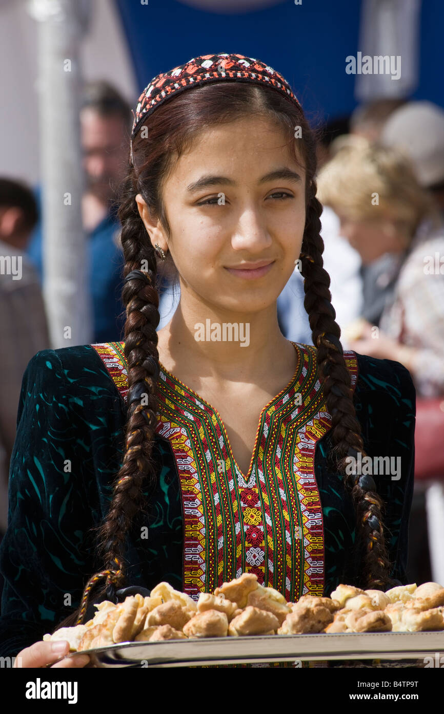 Turkmen girl offering food at a reception for delegates at an ...
