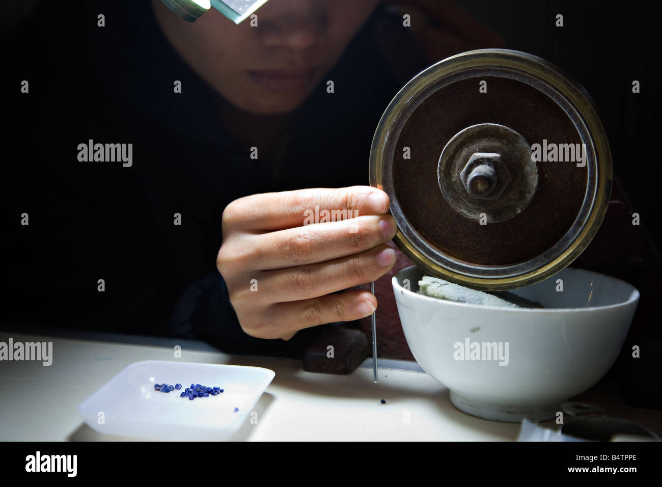 A worker polishing gem stone at factory Stock Photo - Alamy