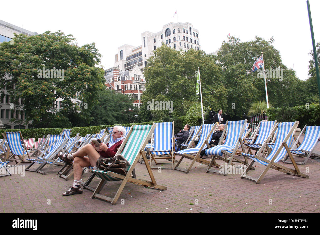 People sit in deck chairs having a break in Westminster London UK Stock ...
