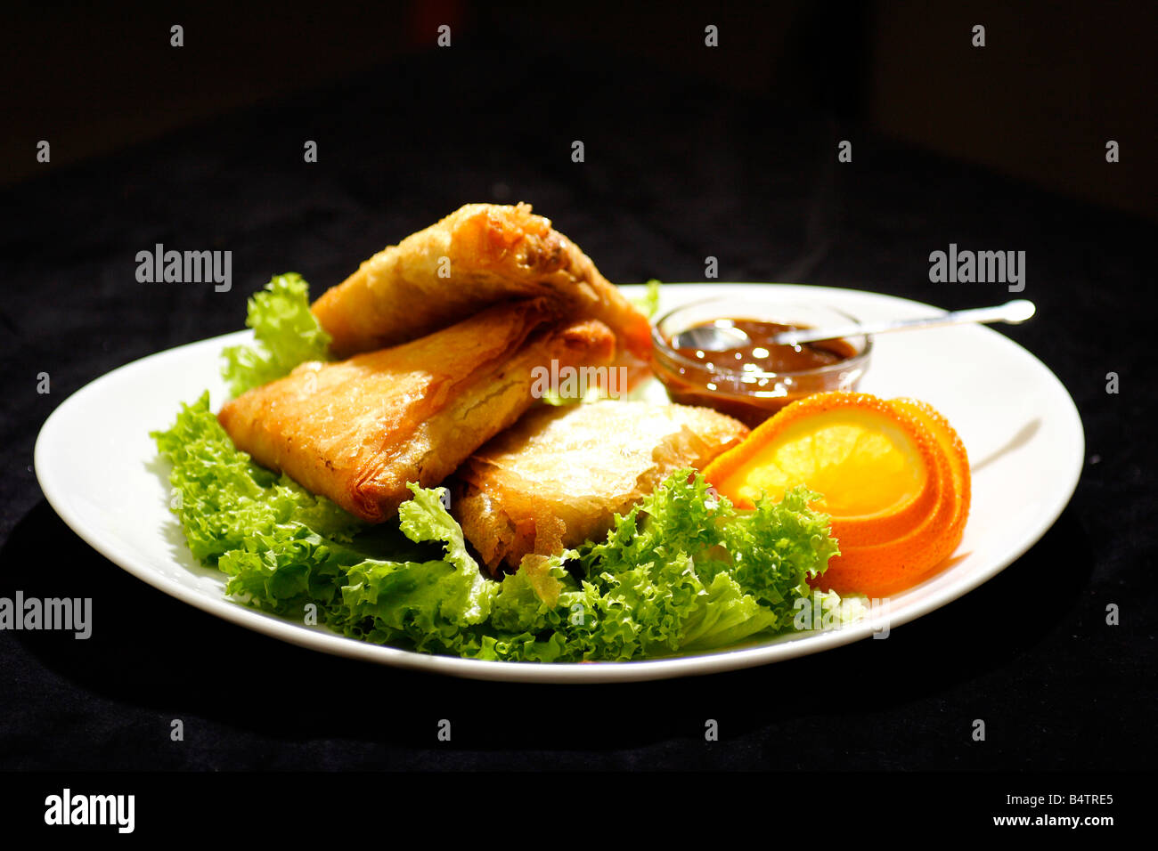samosa with plum sauce and orange salad Stock Photo - Alamy