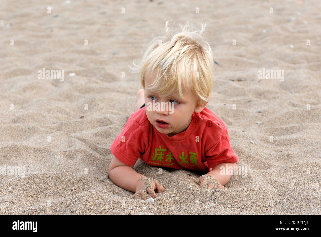 Happy Boy Lying In Sand High Resolution Stock Photography and Images ...