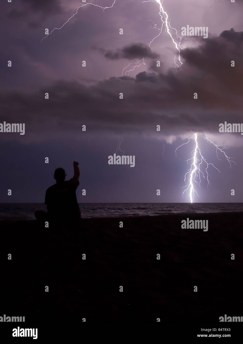 Man watches in awe as a thunderstorm approaches Stock Photo - Alamy