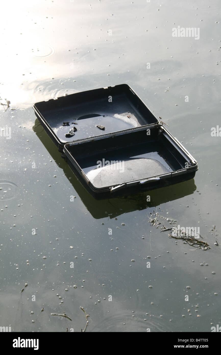 one empty suitcase luggage floating in river Stock Photo - Alamy