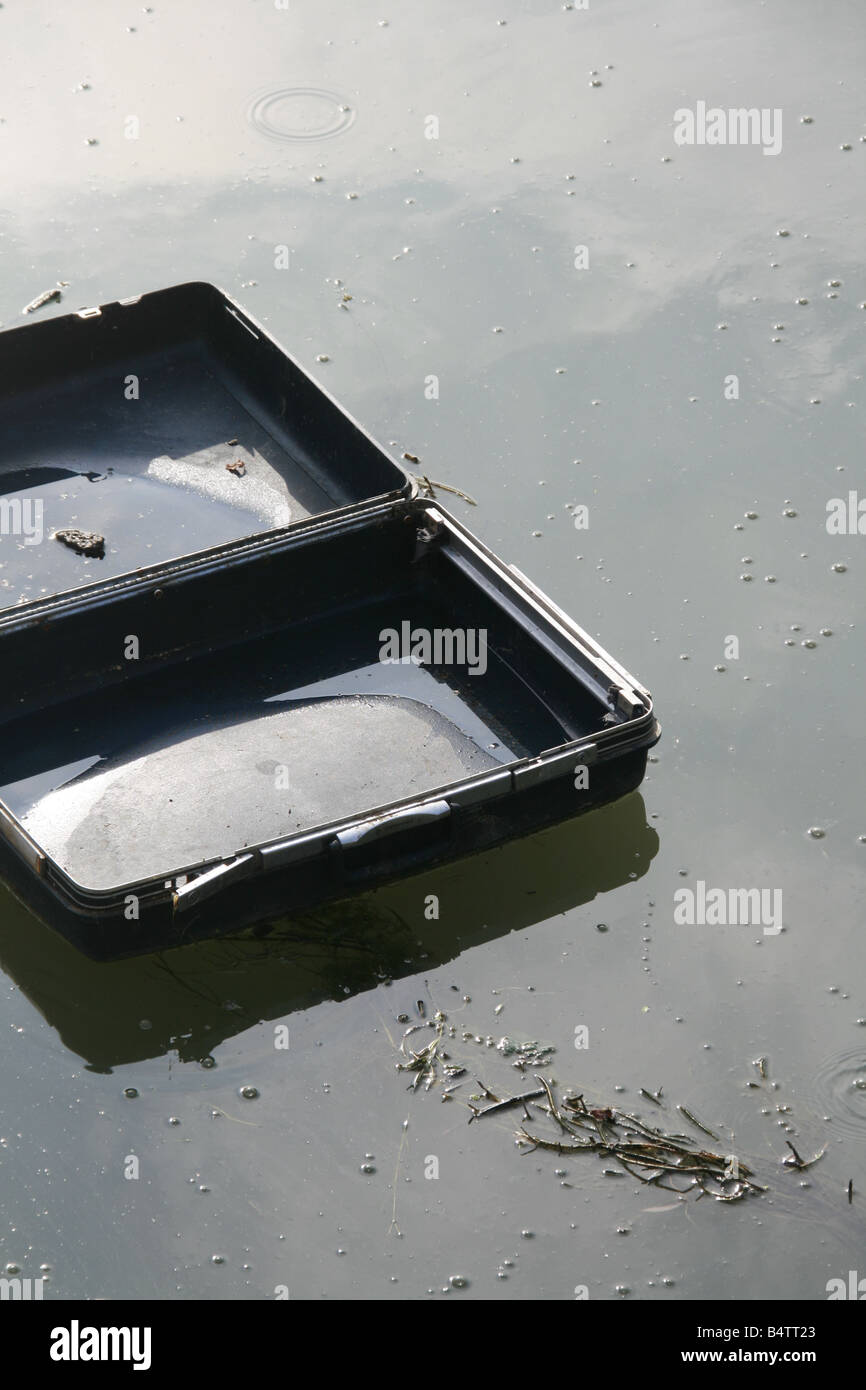 one empty suitcase luggage floating in river Stock Photo - Alamy