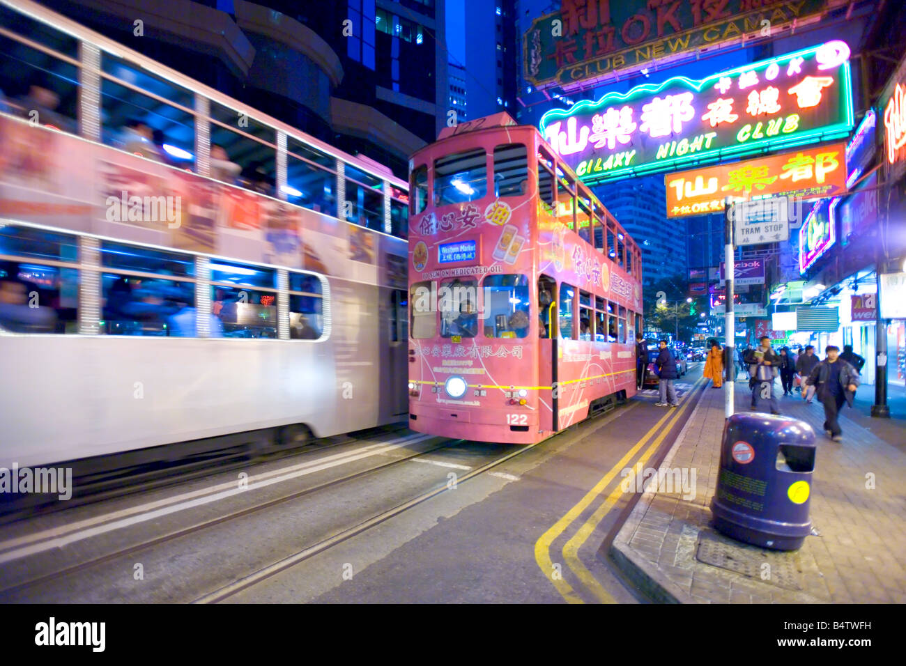 Traditional old trams with motion blur travelling through the Wan Chai ...
