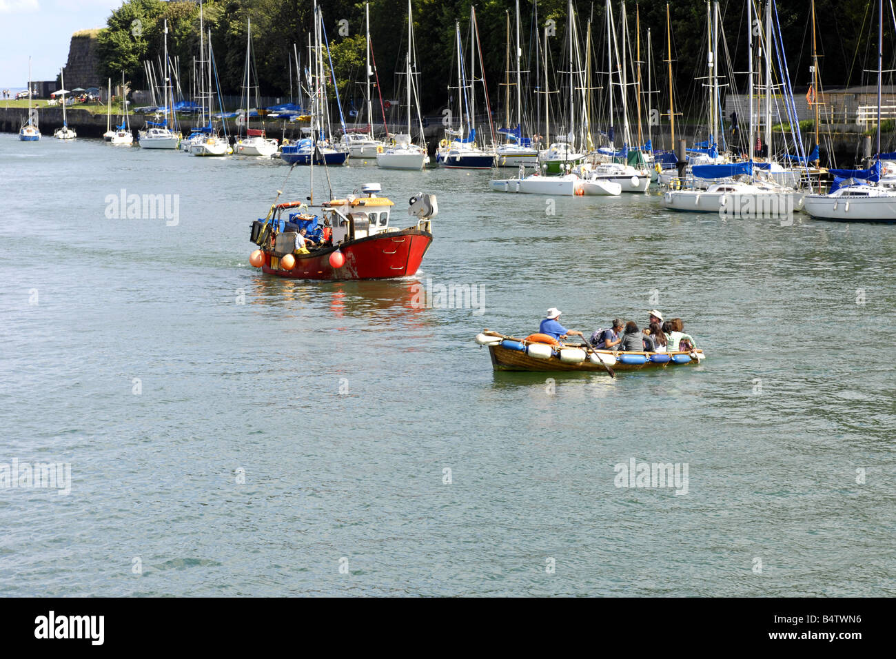A small fishing boat sails back into Weymouth Harbour Dorset with it s ...