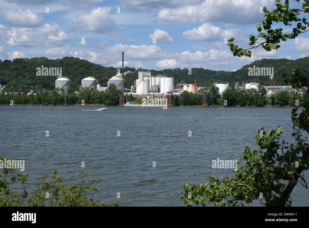 Storage Tanks Along River Stock Photo - Alamy