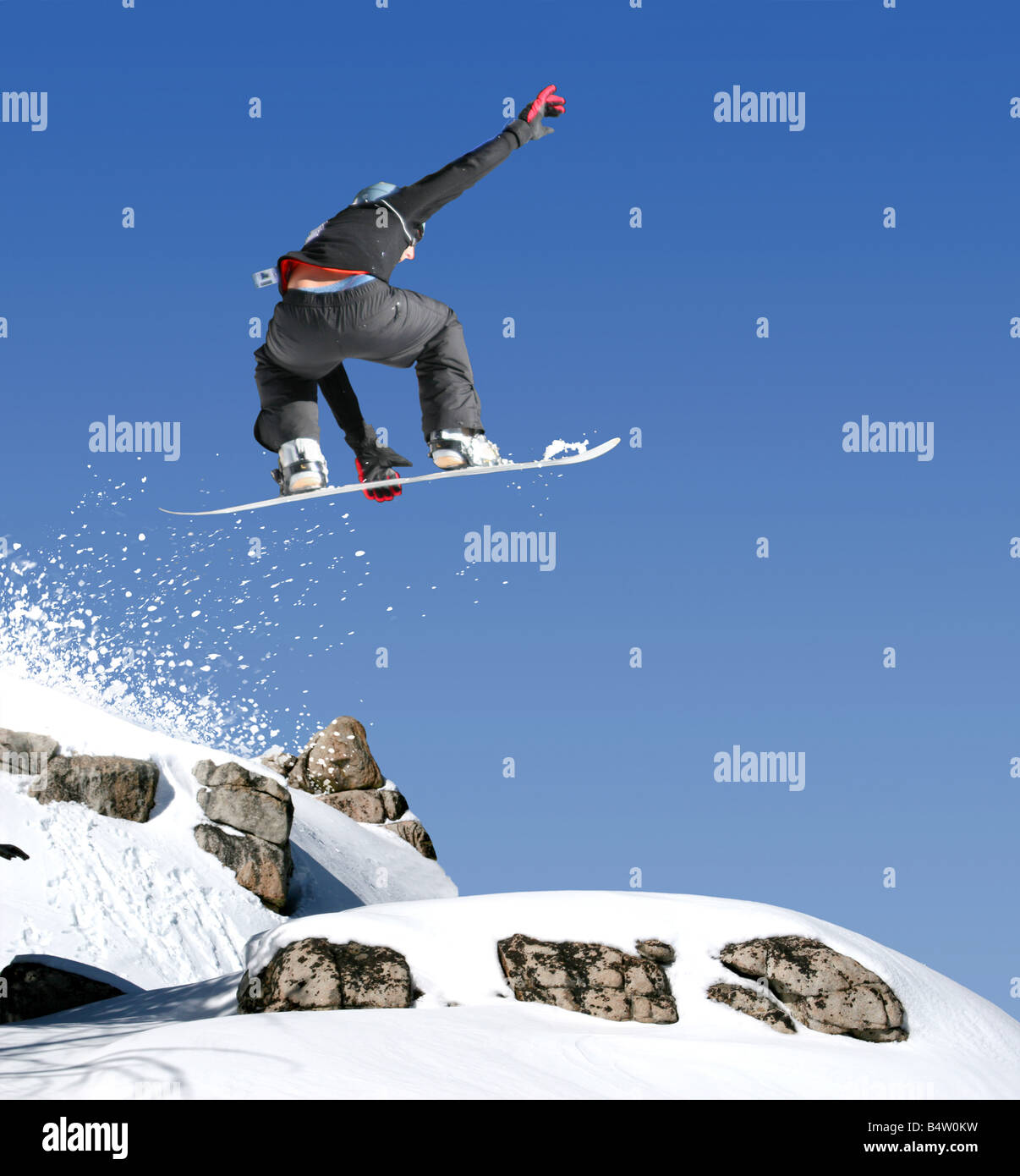 Snowboarder jumping high in the air Stock Photo - Alamy