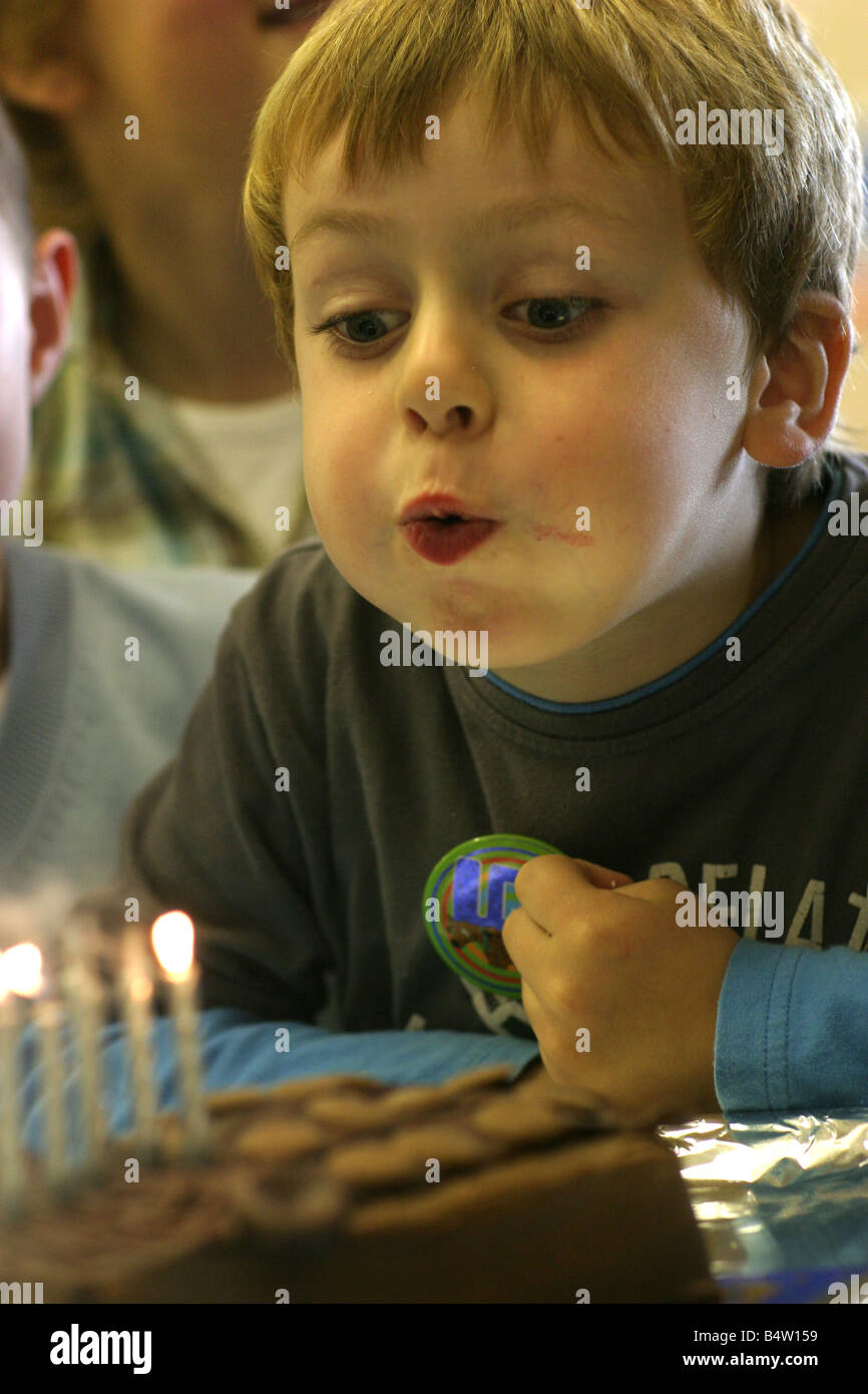 Louis 6th Birthday party Party tea table blowing out the candles on the ...