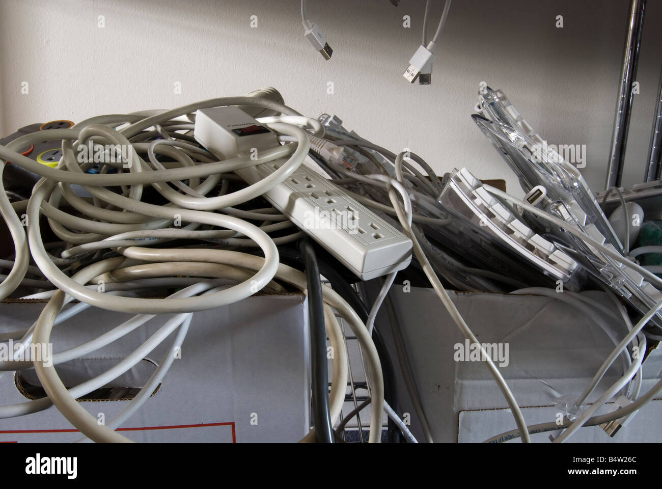 Old computer parts and cables in boxes on a wire shelf Stock Photo - Alamy