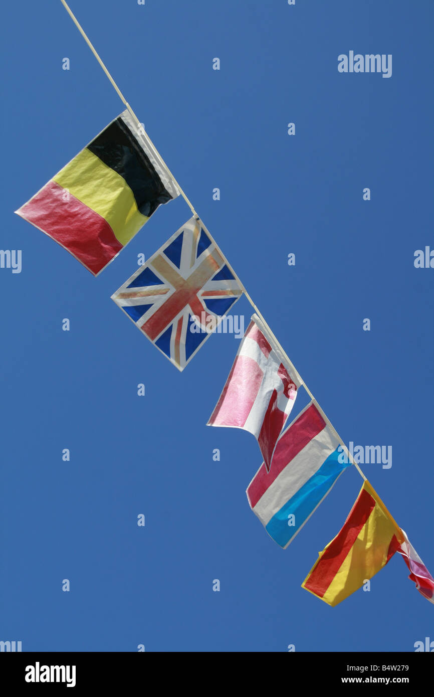 old faded international flags flying in wind in sun Stock Photo - Alamy