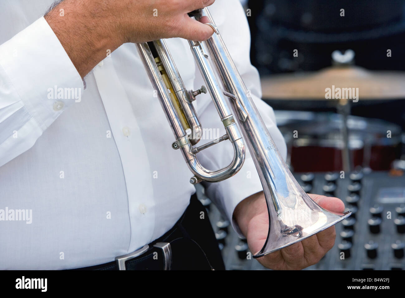 A man playing a trumpet in a recording studio Stock Photo - Alamy
