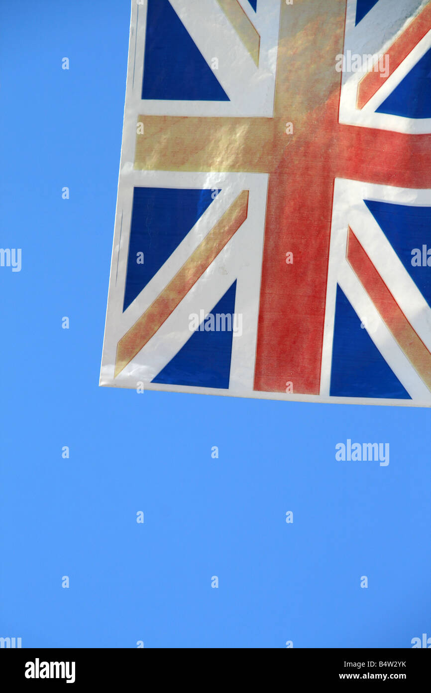 old faded union jack flag flying in wind in sun Stock Photo - Alamy