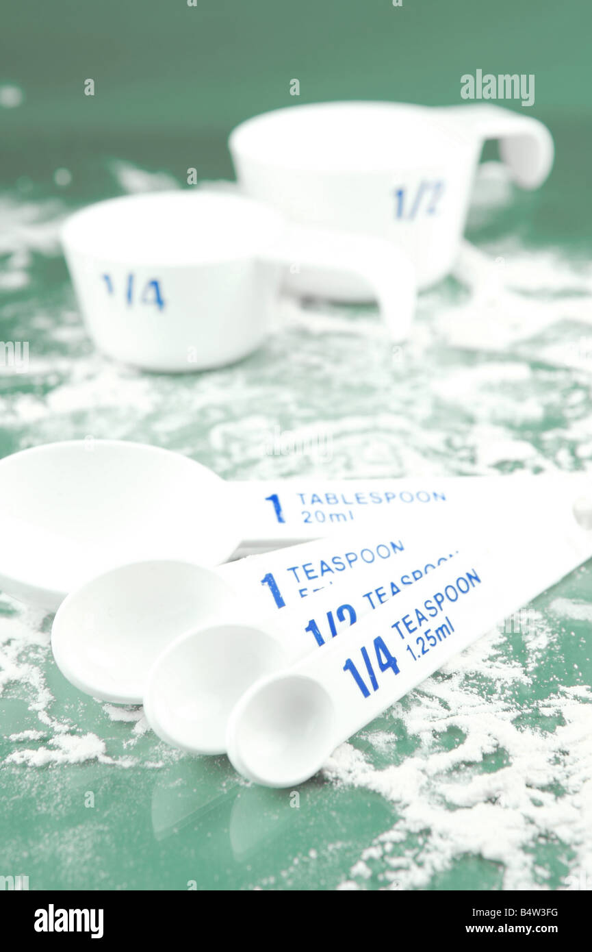 Measuring cups isolated against a green background Stock Photo - Alamy