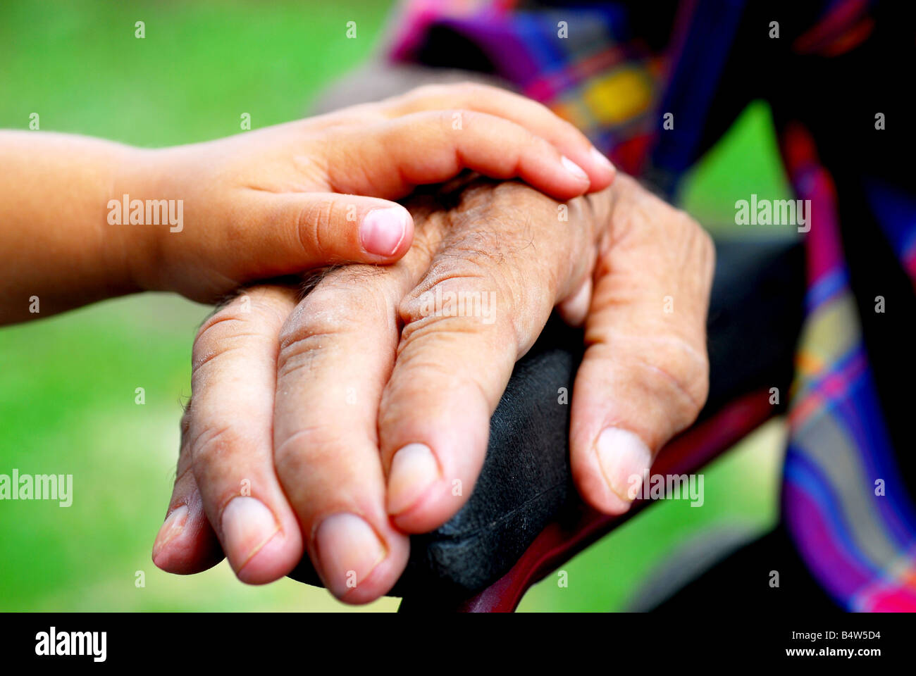 little girl holding a handicapped man`s hand Stock Photo - Alamy