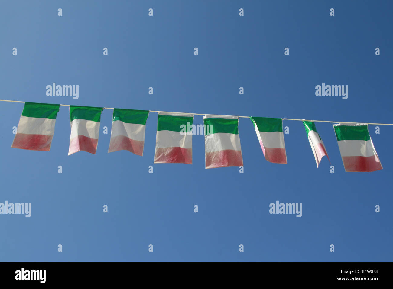 old faded italian flags flying in wind in sun Stock Photo - Alamy