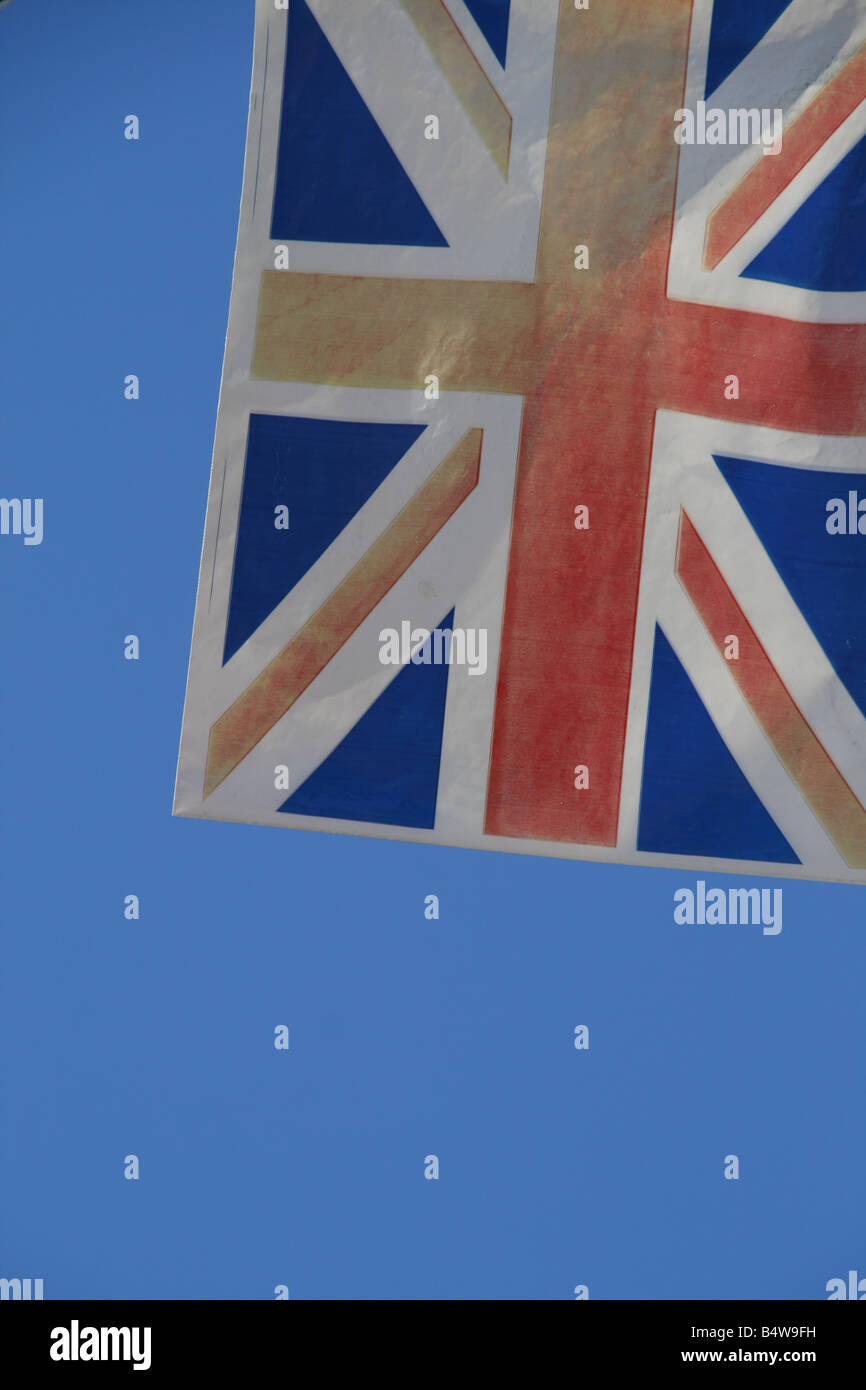old faded union jack flag flying in wind in sun Stock Photo - Alamy