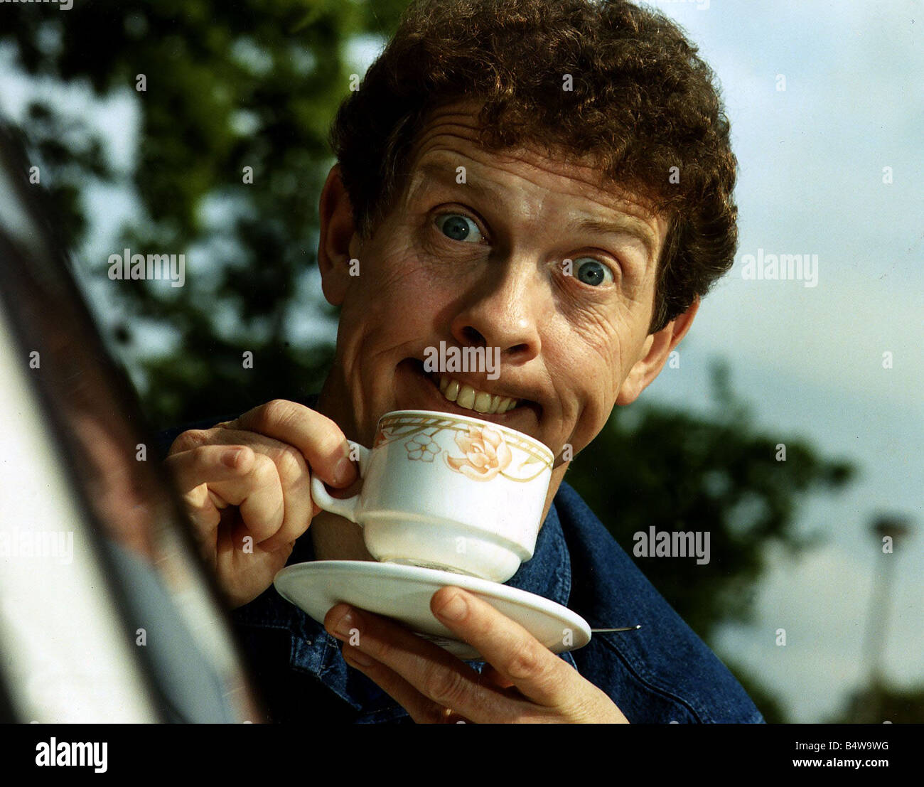 Phil Cool Comic pulling funny face holding cup and saucer Dbase Stock ...