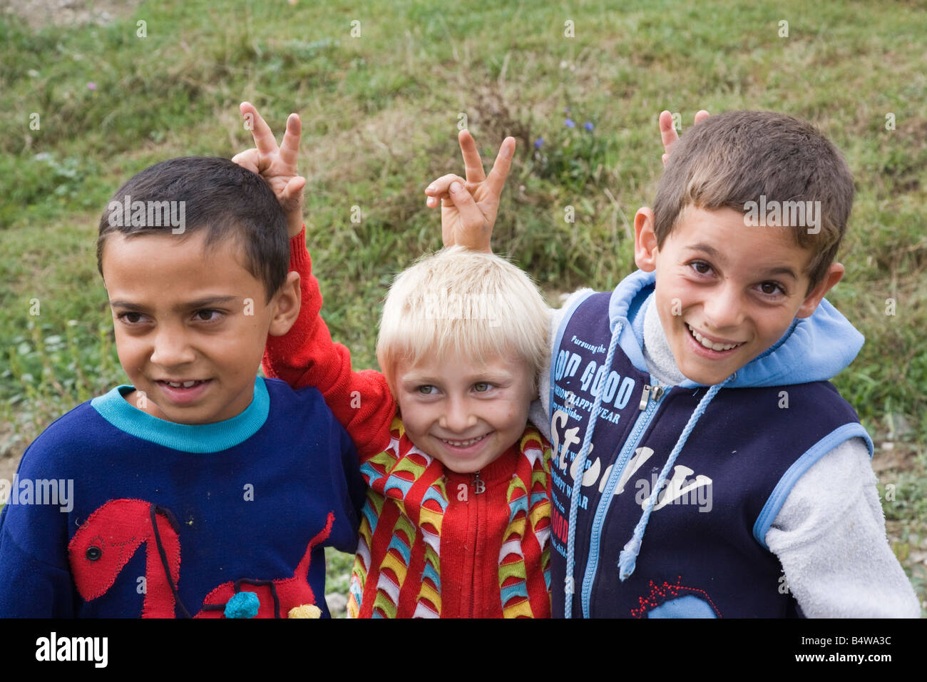 Three mischievous Romanian village boys posing for a photograph ...