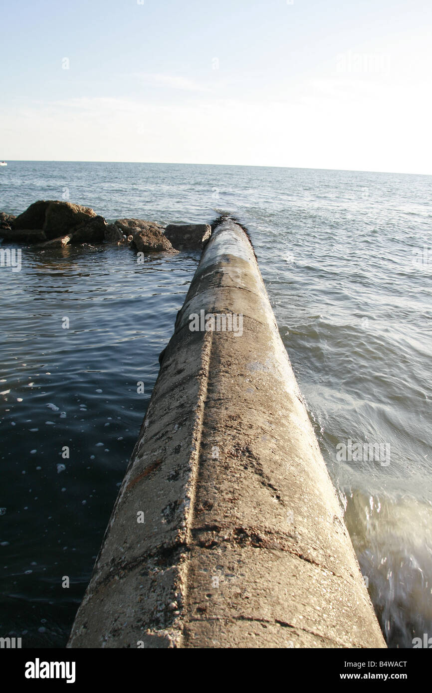 long waste pipe going into the sea Stock Photo - Alamy