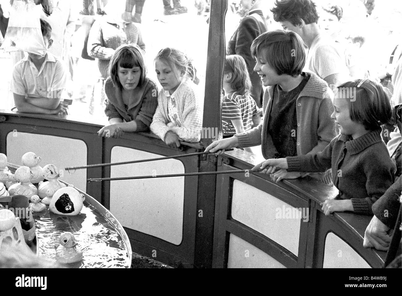 Children enjoying a game of 'Hook-a-Duck' at a stall. Hearsall Common ...