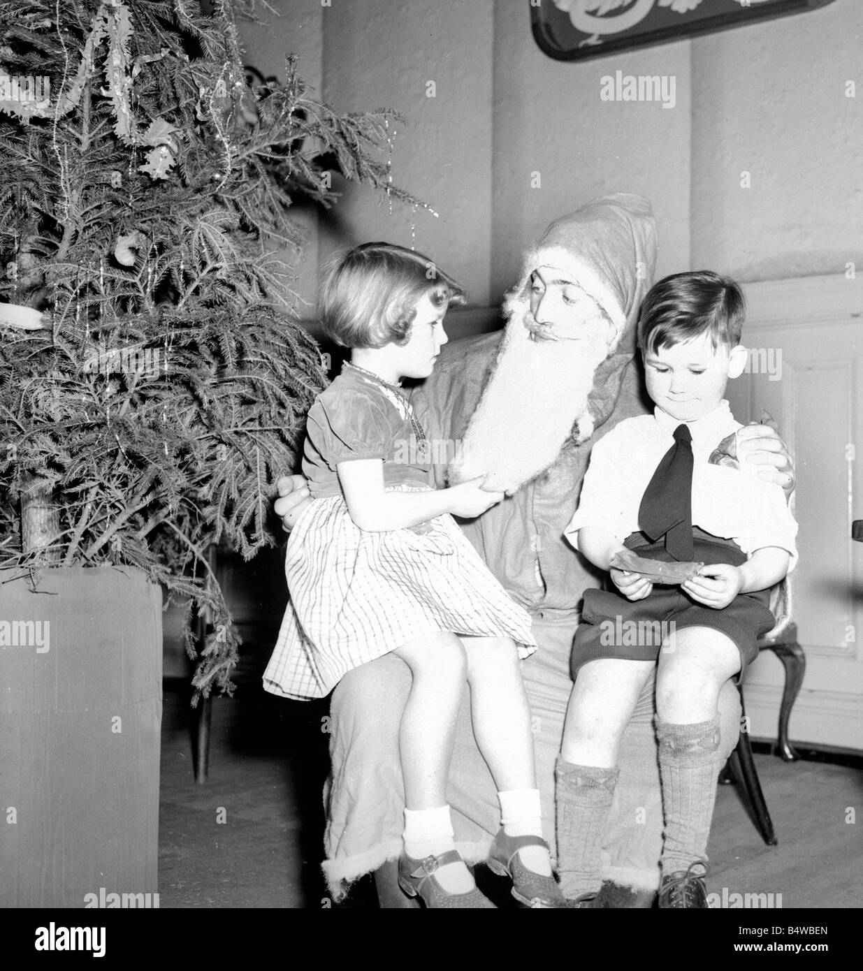 A Teddy Boy dressed as Father Christmas hands out presents at the ...