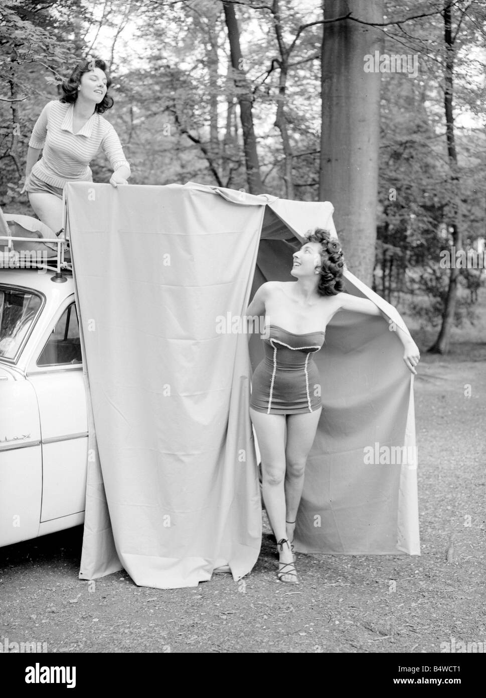 Two reveille models seen here demonstrating the new car rack tent ...