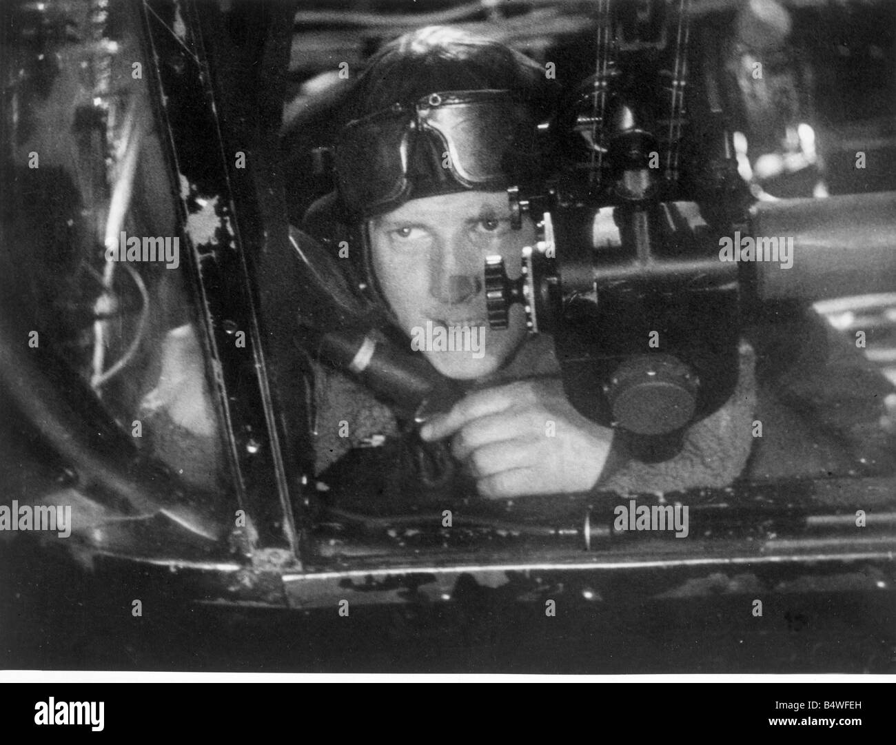 A bomb aimer face down in steel and perspex drops a bomb from the plane ...