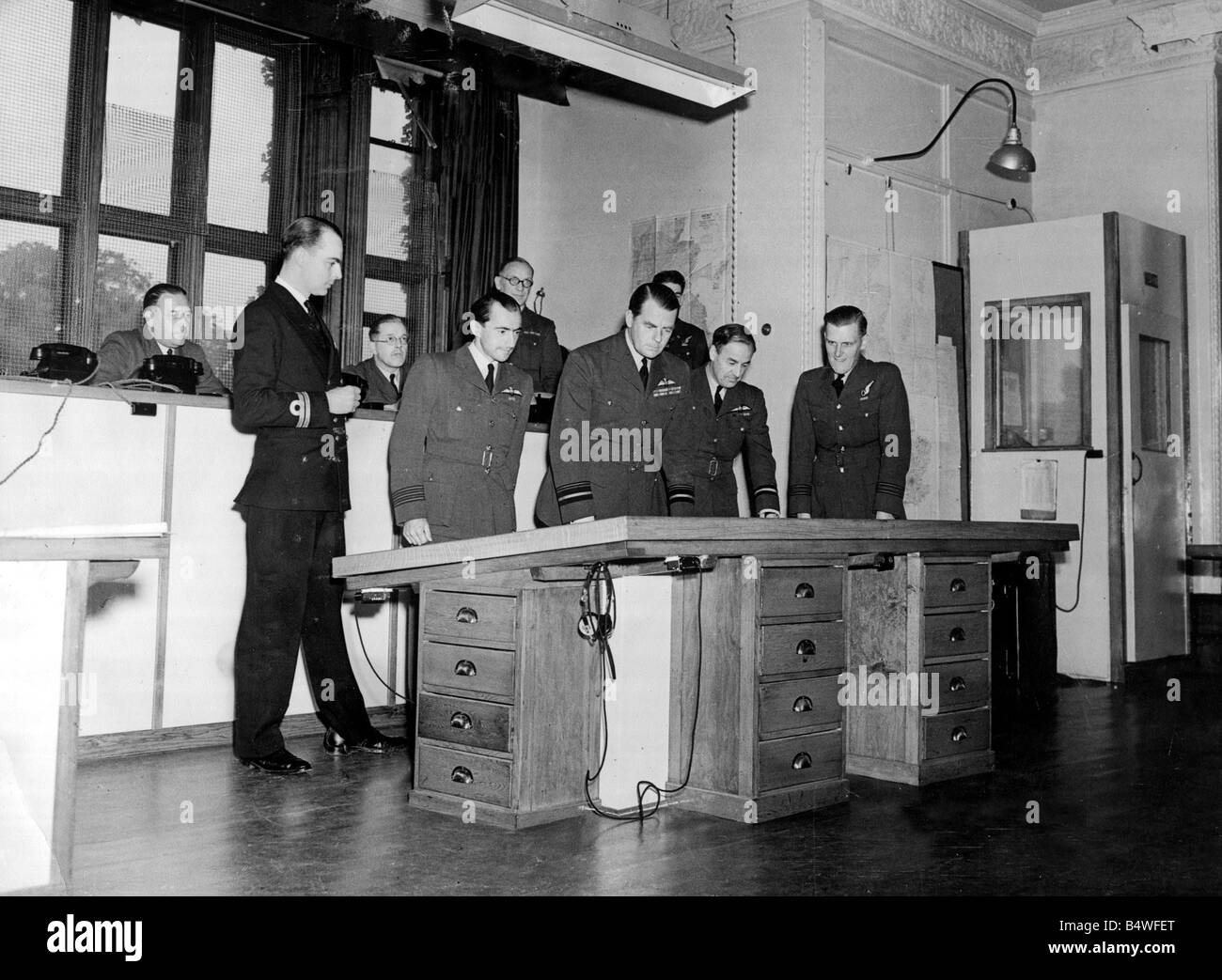 RAF officers study intelligence reports and maps as they plan a large ...