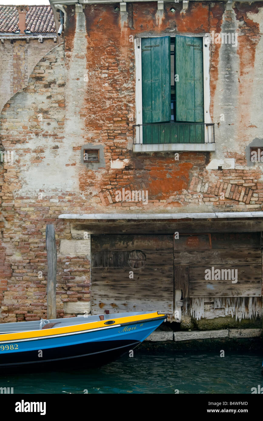 Moored boat & crumbling buildings along the Rio dei Mendicanti ...