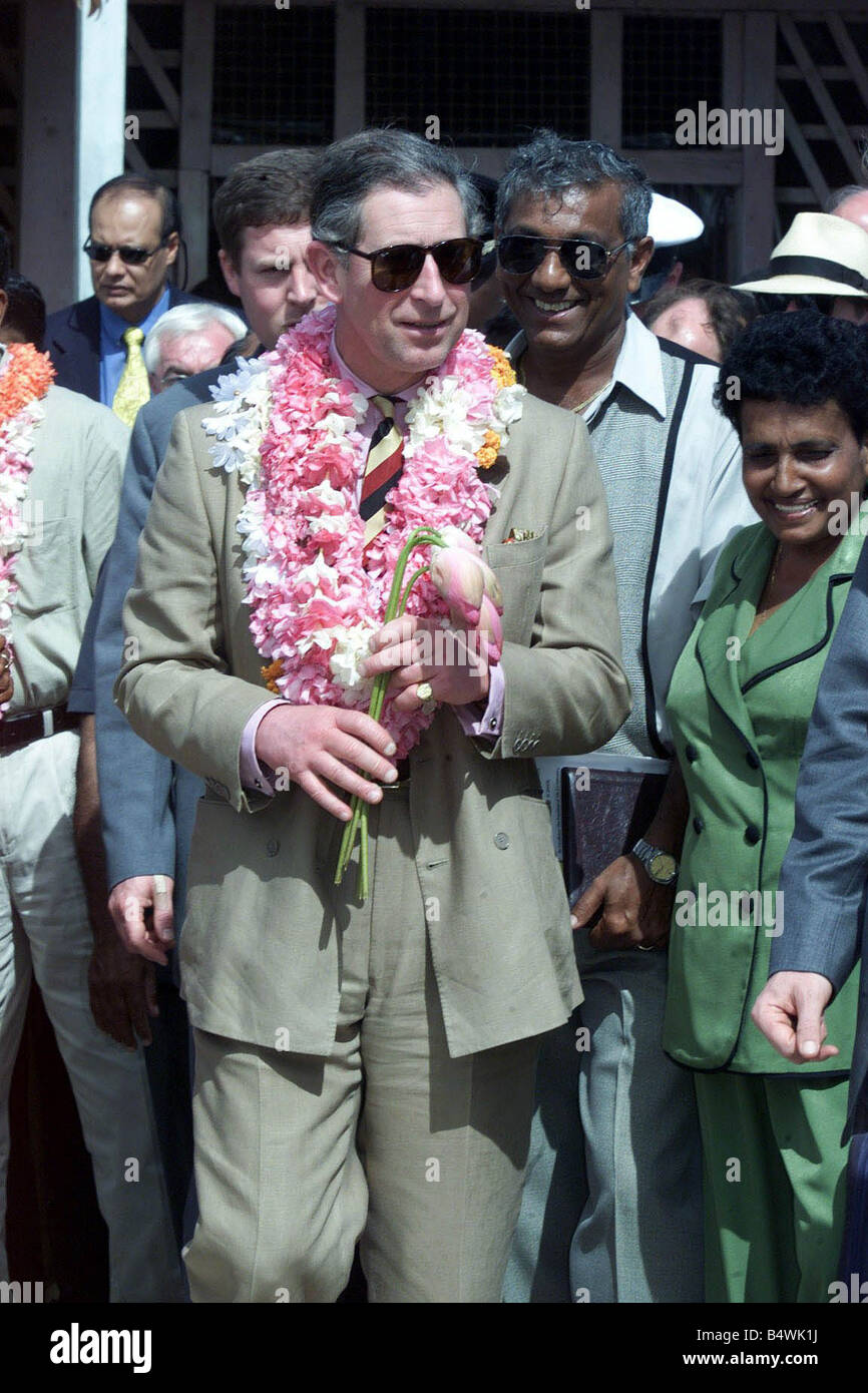 Prince Charles wearing a garland during a visit to a sugar plantation ...
