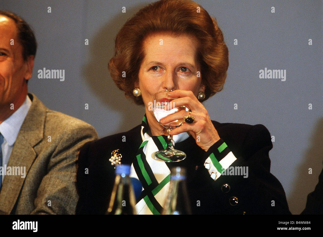 Prime Minister Margaret Thatcher drinking a glass of water at a ...